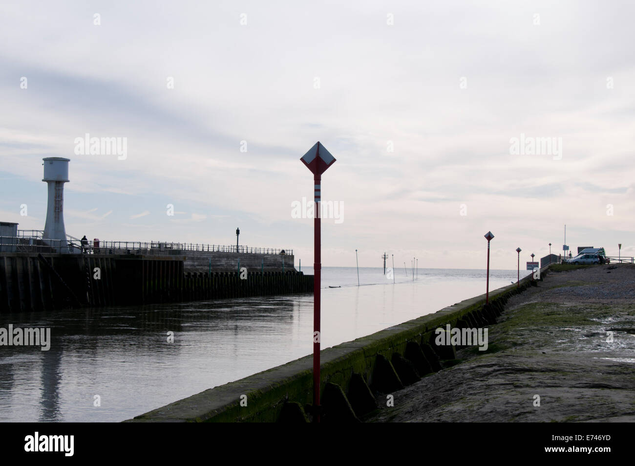 Littlehampton harbour entrance on a calm February day which includes ...