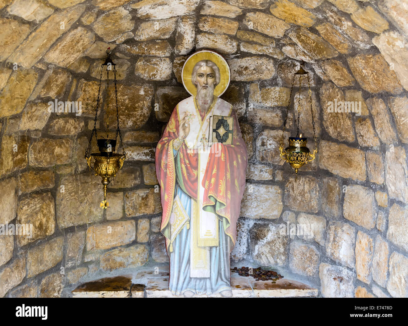 A picture of a Christian Saint with rocks Stock Photo - Alamy