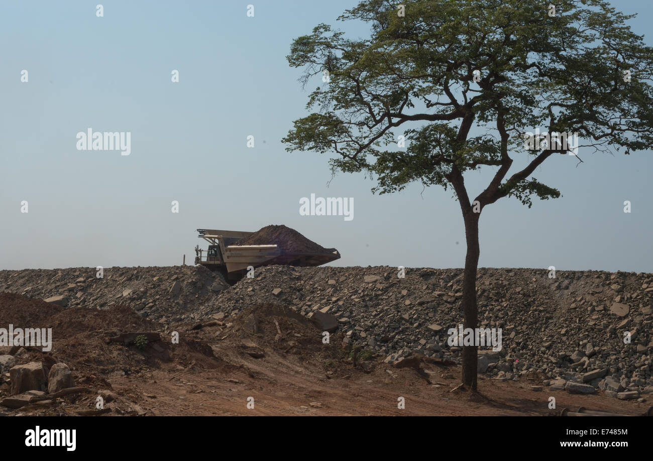 A massive hybrid diesel/ electric Hitatchi mining truck drives past on ...