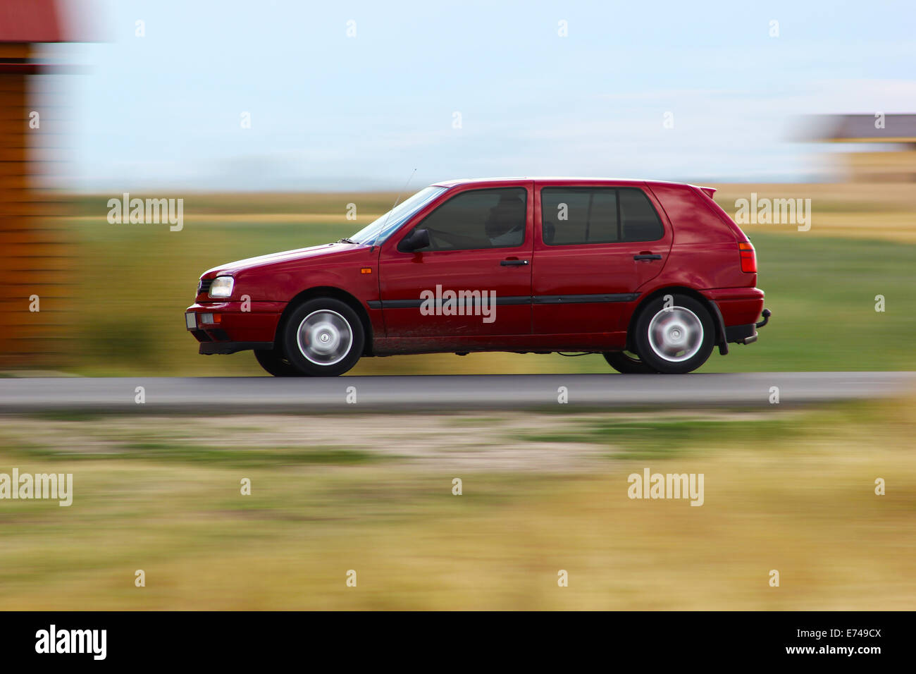 red car go fast on the street Stock Photo - Alamy
