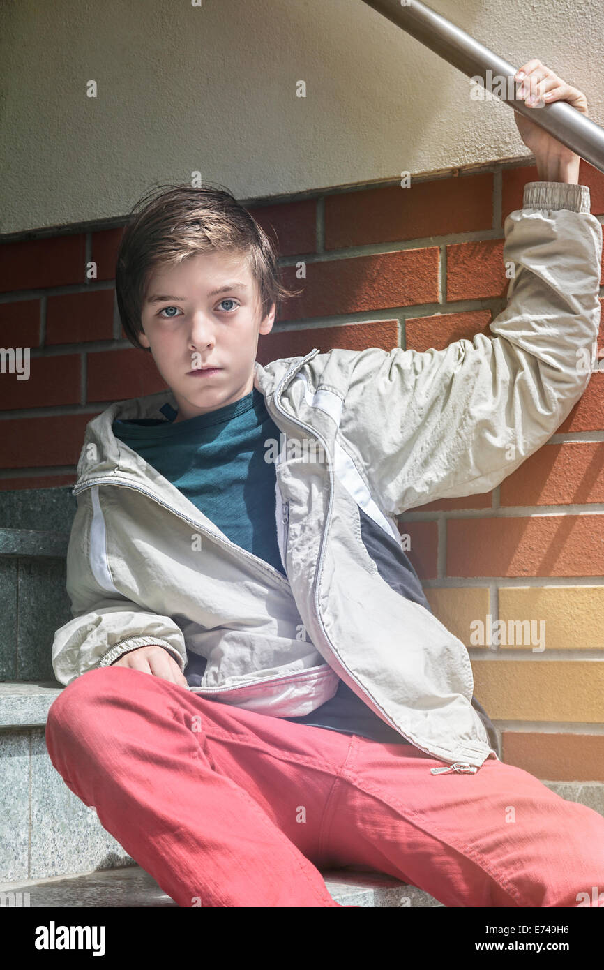 cool teenager boy sitting on steps Stock Photo - Alamy