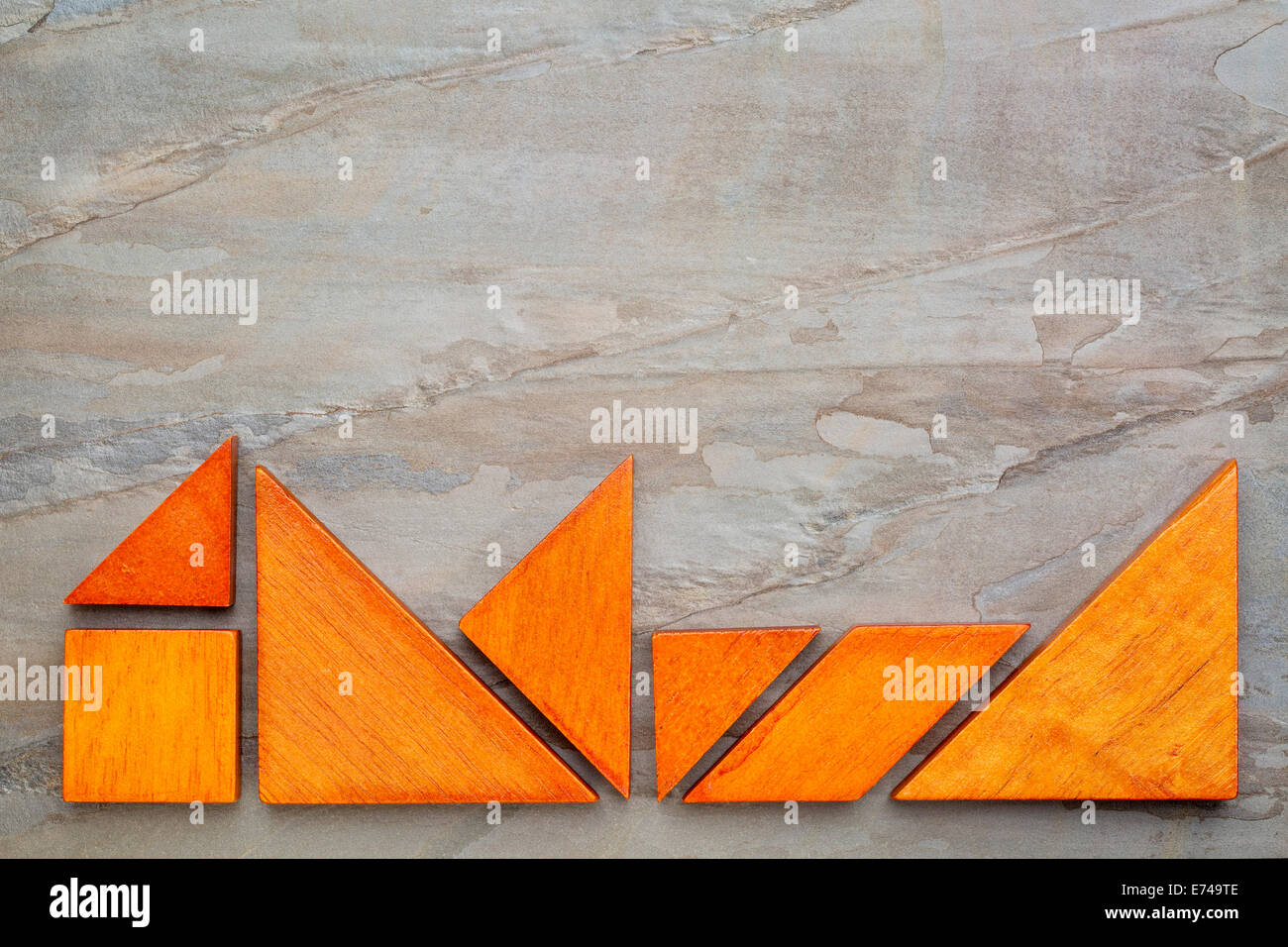 seven tangram wooden pieces, a traditional Chinese puzzle game, on a ...