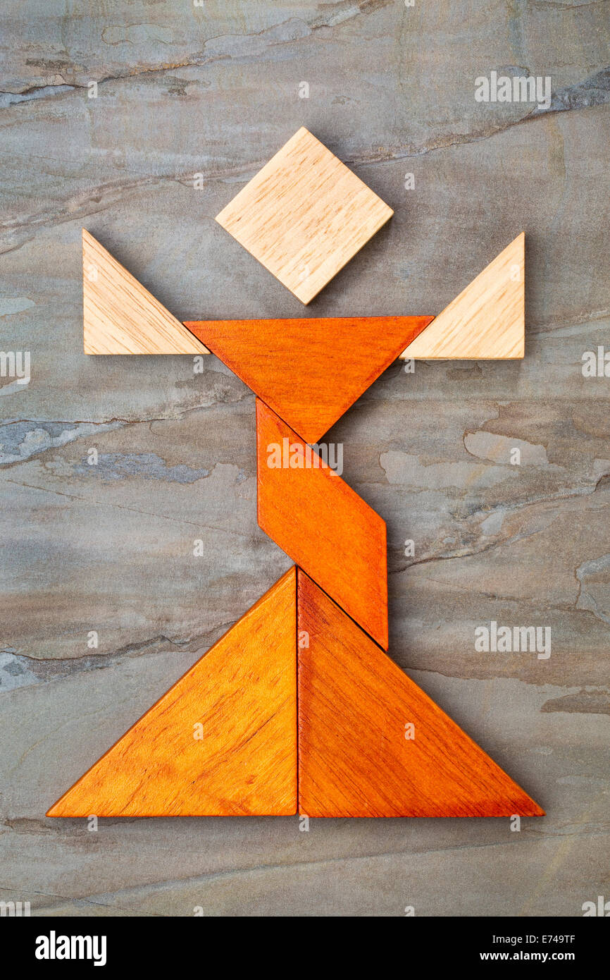 abstract figure of a female dancer built from seven tangram wooden ...
