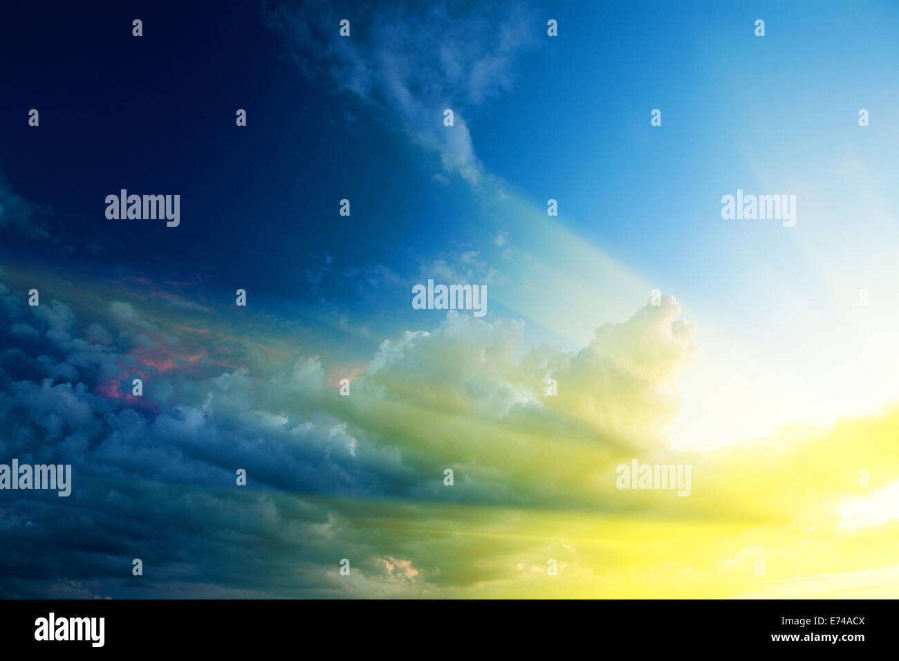 The burst of the sunset over dramatic sky Stock Photo - Alamy