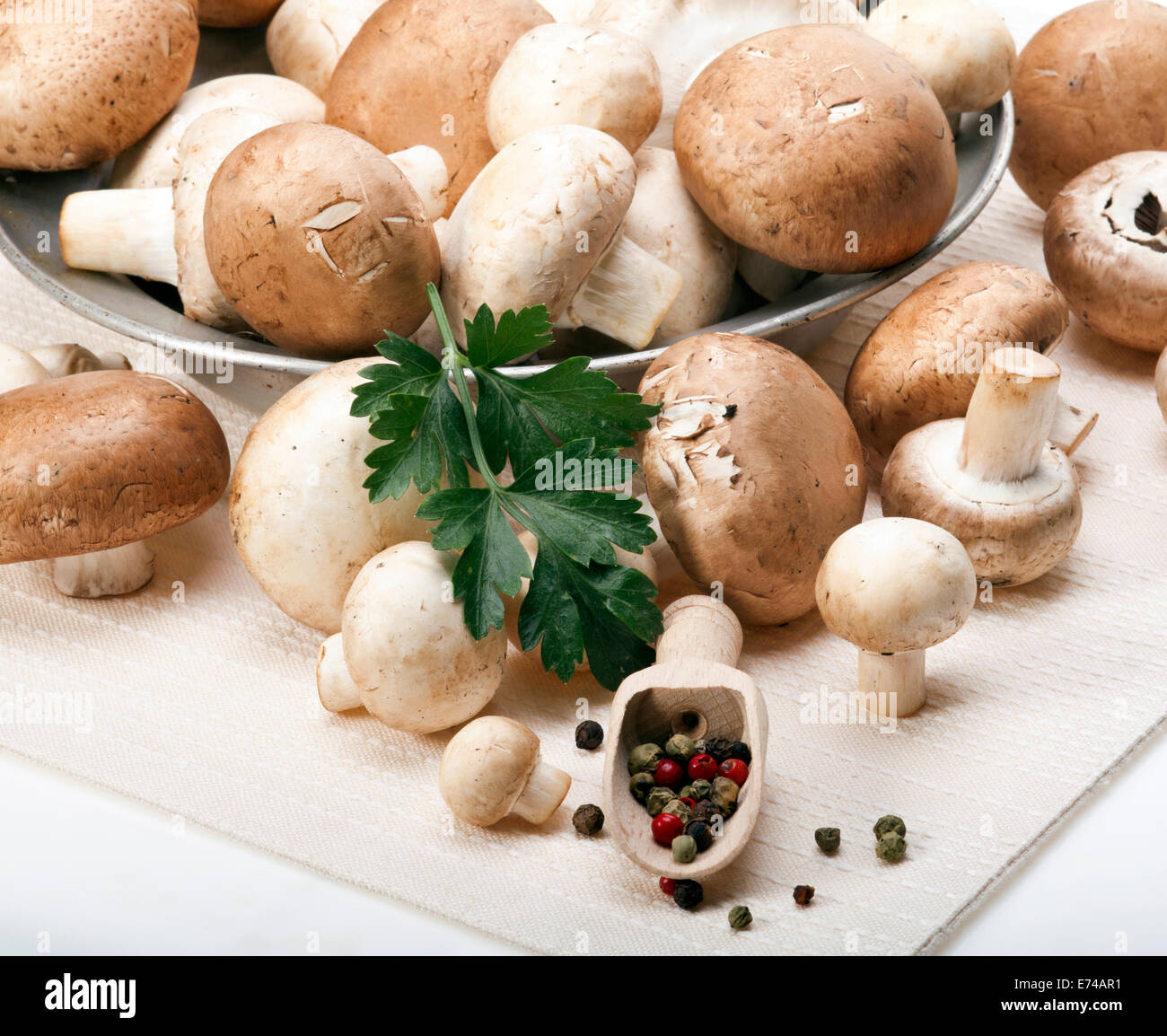 Button or Champignon and Portabello mushrooms in old metal plate with ...