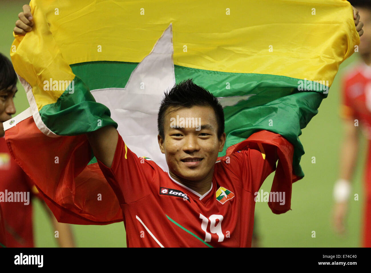 Aung Kyaw Naing lifts the Myanmar flag at the Rizal Memorial field ...