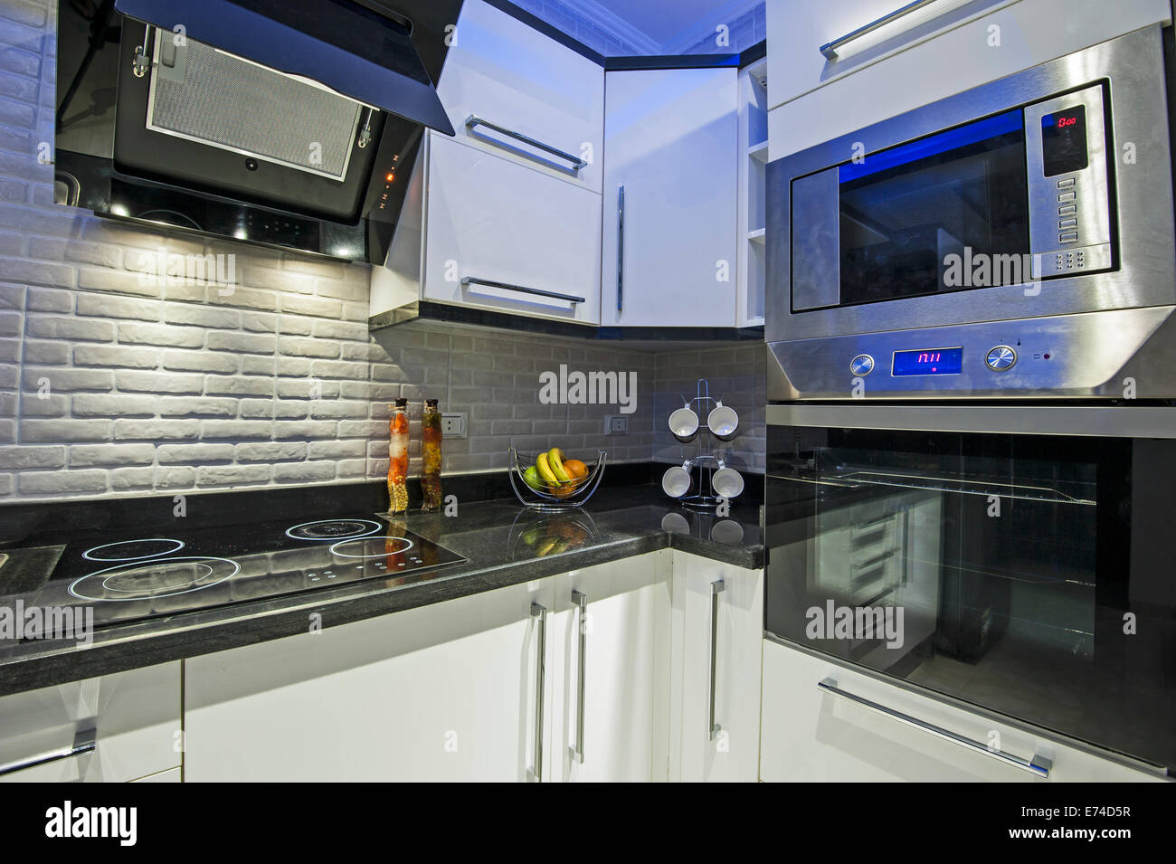 Interior design of luxury apartment kitchen area with cooker and oven ...