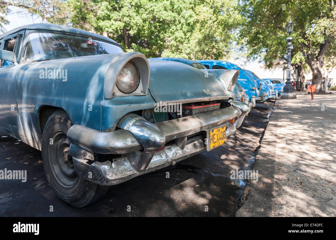 Battered and dirty blue vintage American car parked on the street in ...