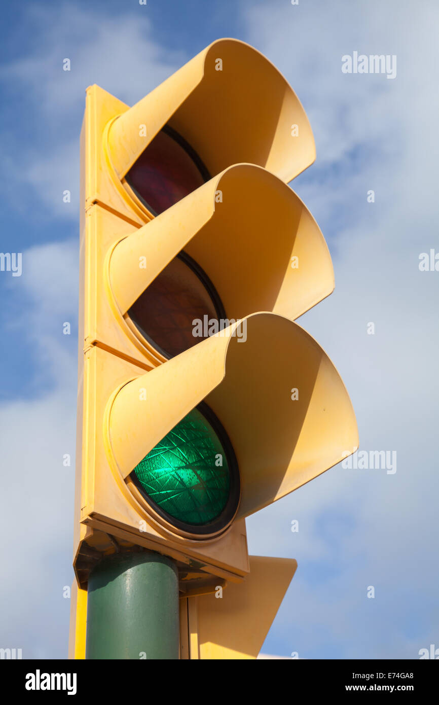 Yellow traffic light shows green allowed signal Stock Photo - Alamy