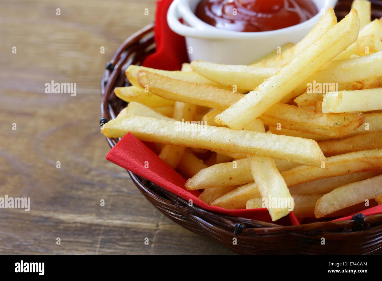 Traditional French fries with ketchup in a wicker basket Stock Photo ...