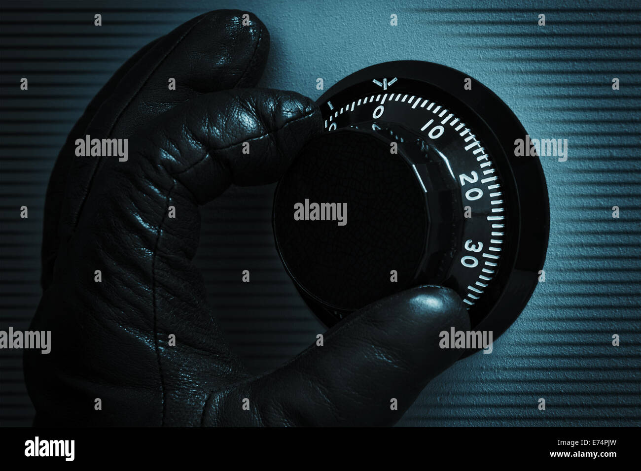 Hand of thief opens combination safe lock Stock Photo - Alamy