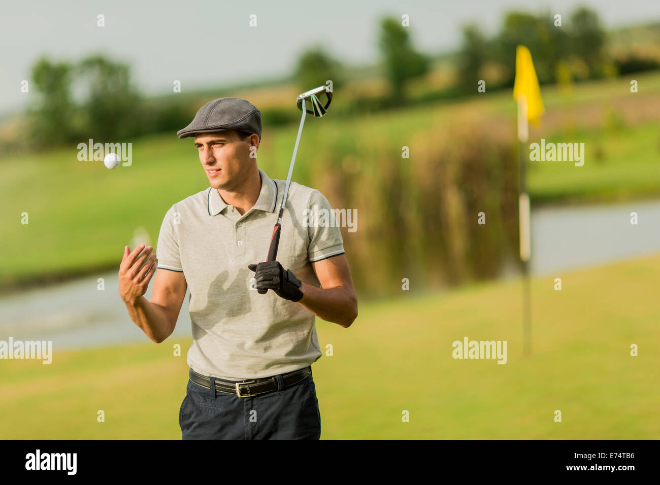 Young man playing golf Stock Photo - Alamy