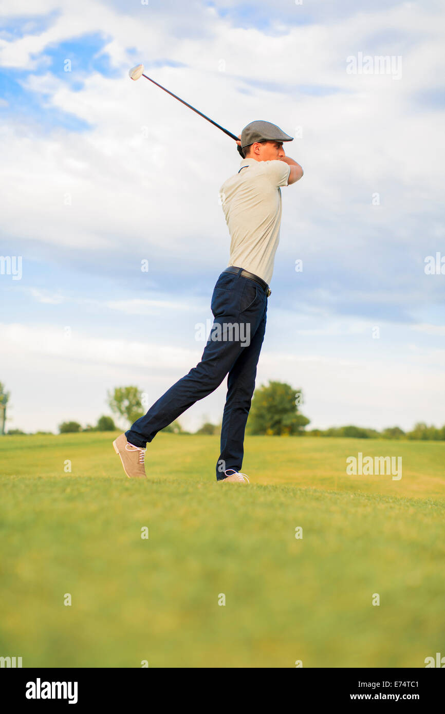 Young man playing golf Stock Photo - Alamy