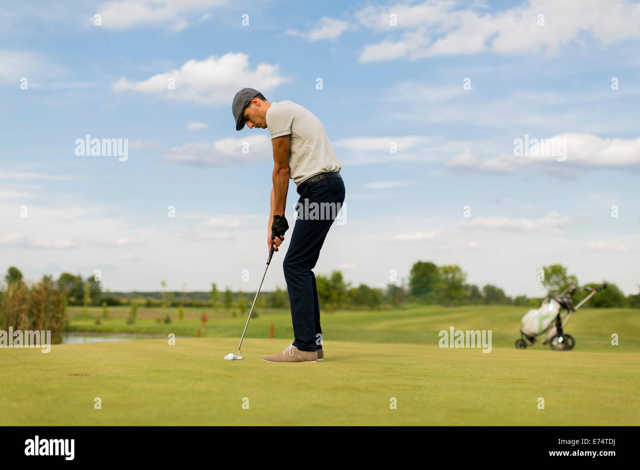 Young man playing golf Stock Photo - Alamy