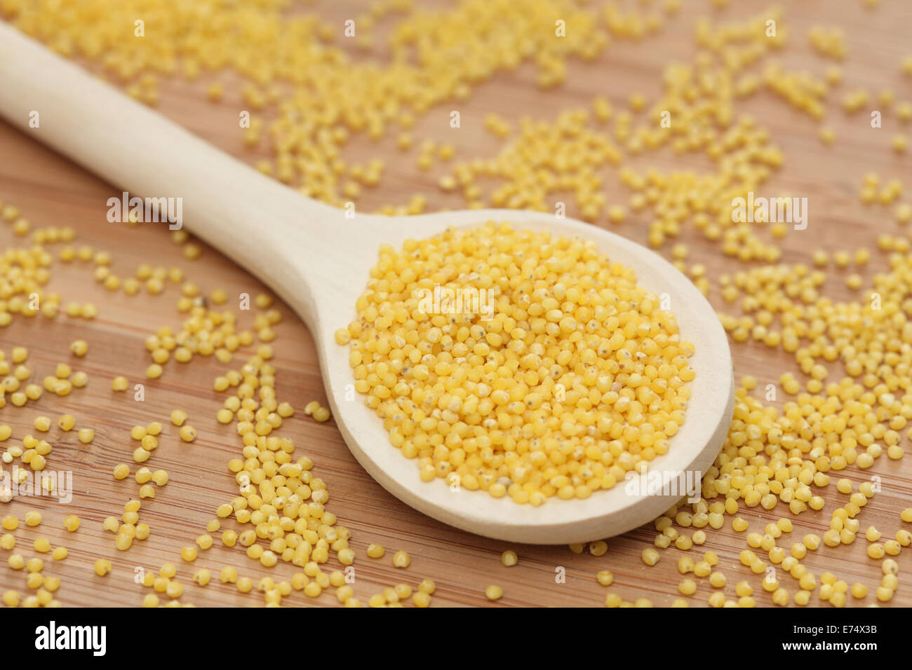 Millet in wooden spoon. Close-up Stock Photo - Alamy