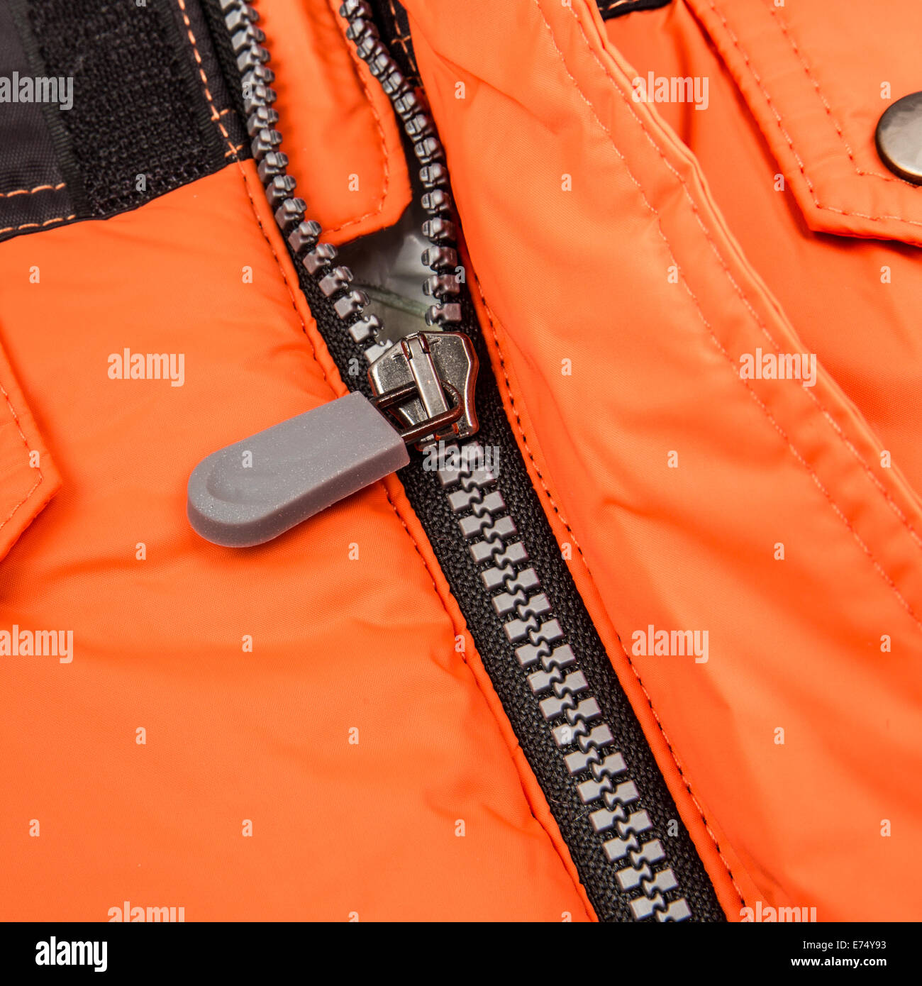 Close up zipper on an orange background Stock Photo - Alamy