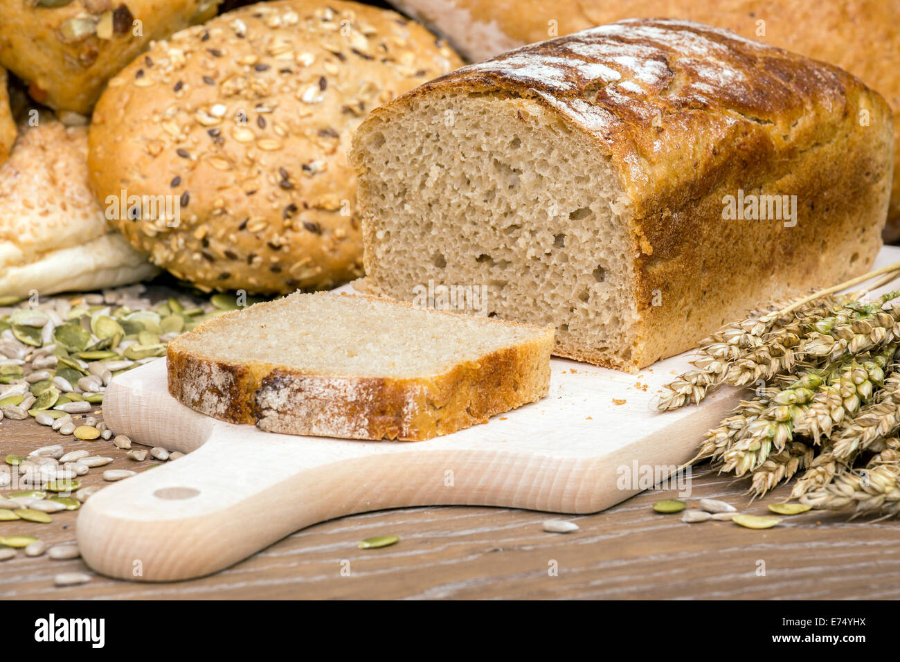 Freshly baked loaf of bread on a wooden bread-board Stock Photo - Alamy