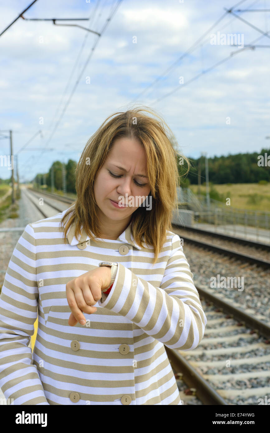 Woman looking at watch train station hi-res stock photography and ...