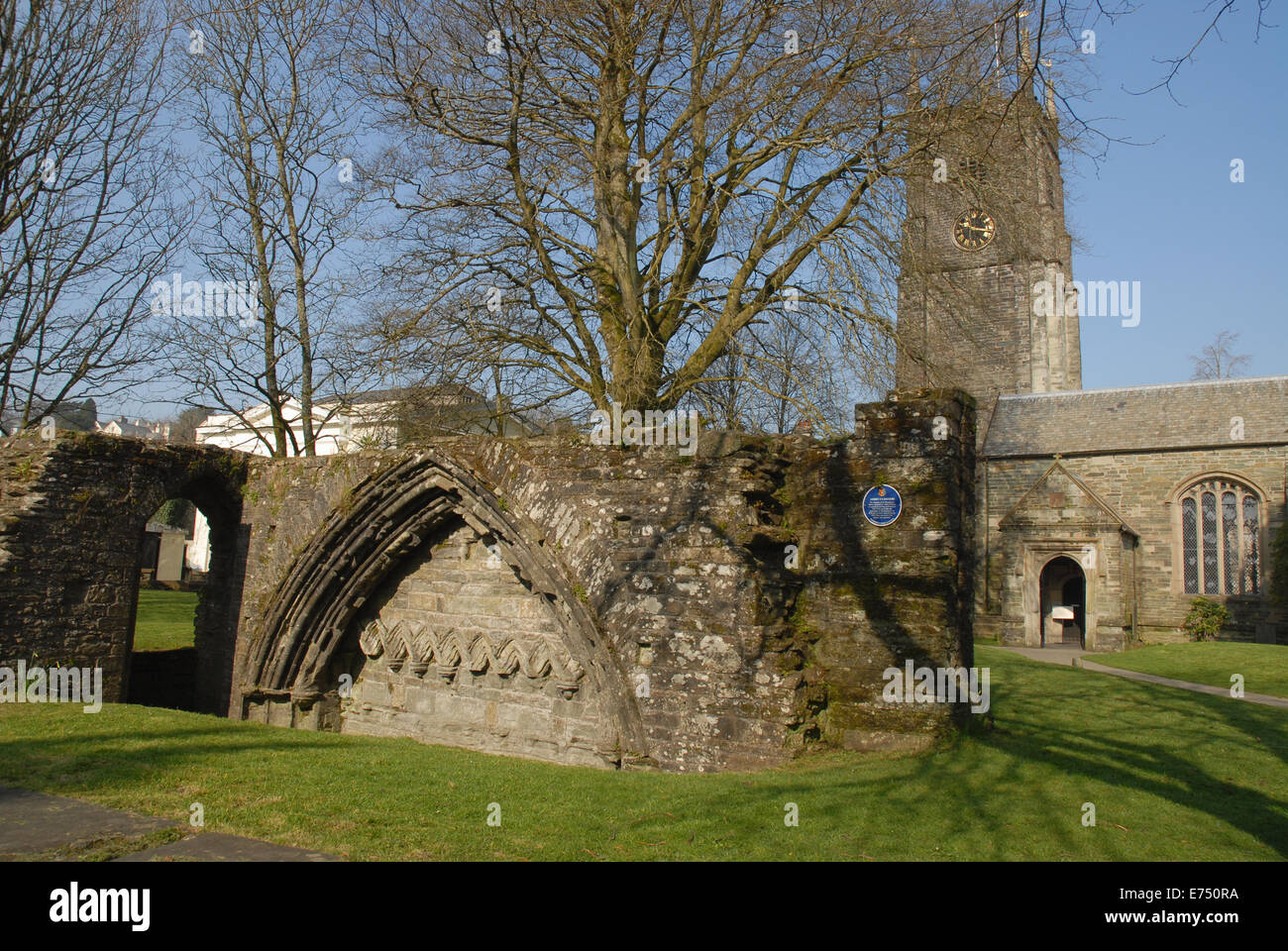 Ruined wall of Abbey Cloisters with St Eustachius' parish church in the ...
