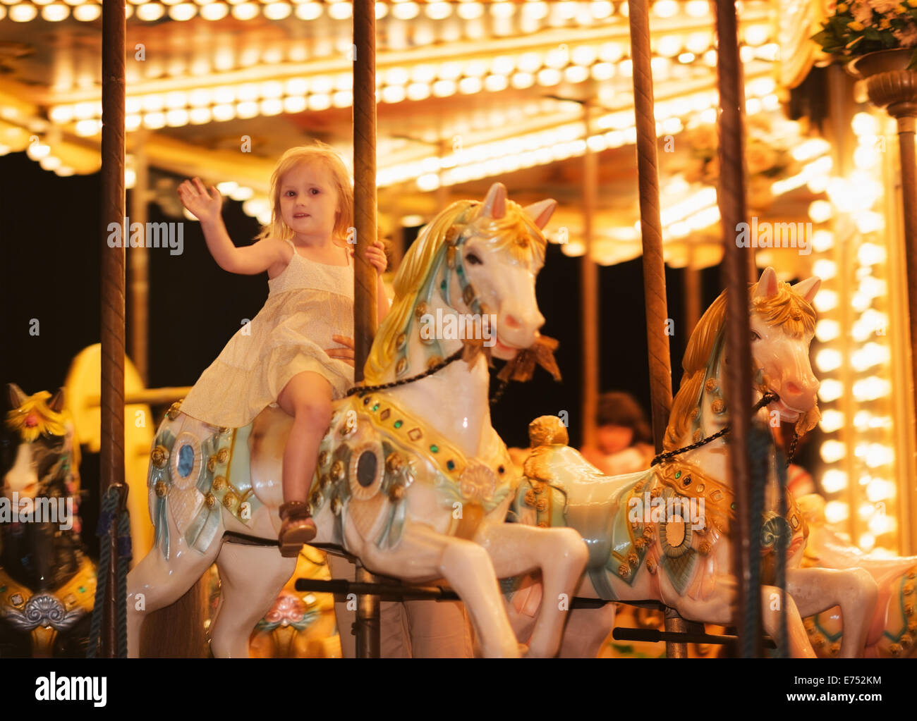 Girl riding on merry go round hi-res stock photography and images - Alamy