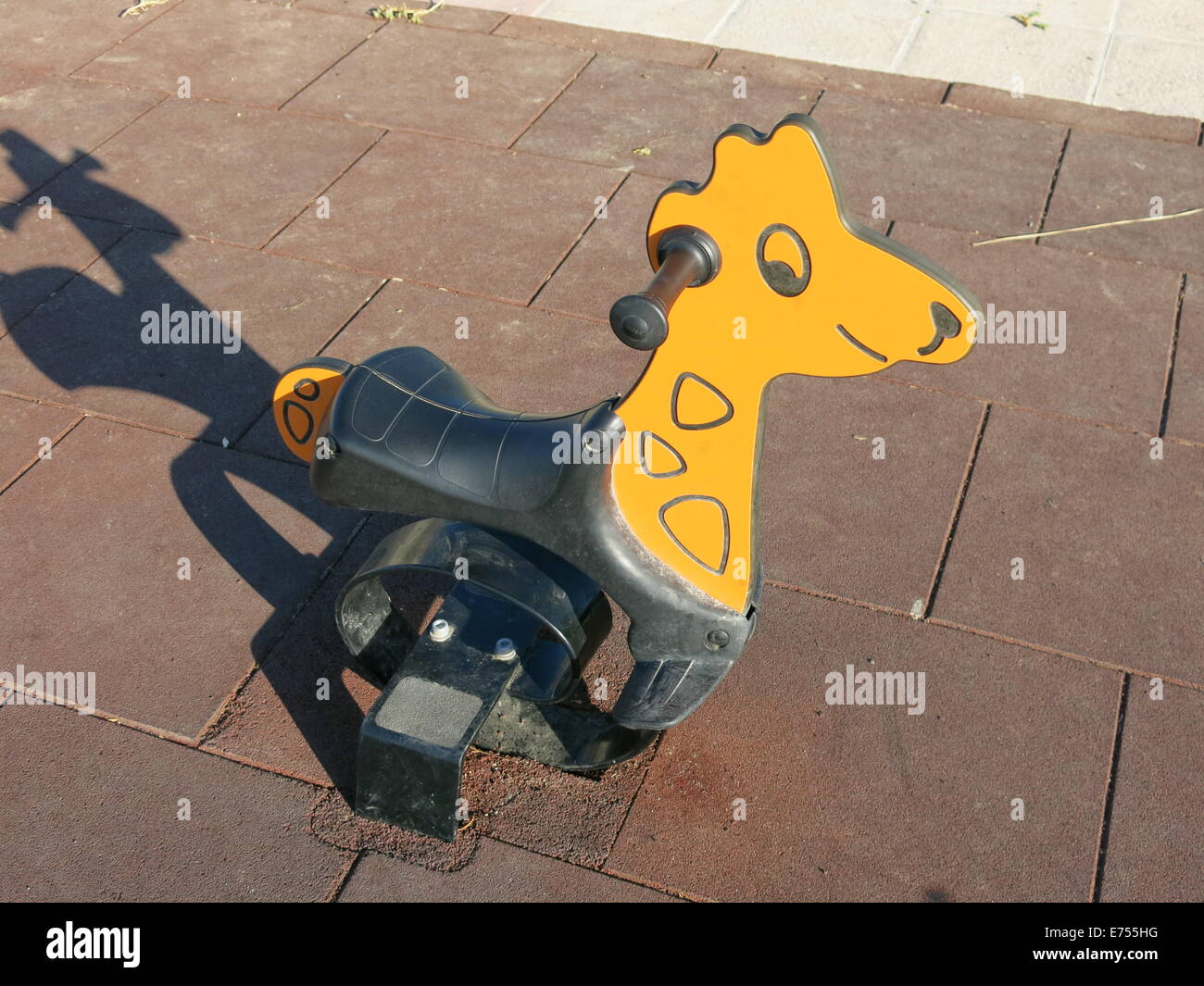 Spring toy giraffe, children's toy at the playground.Concept: free time ...