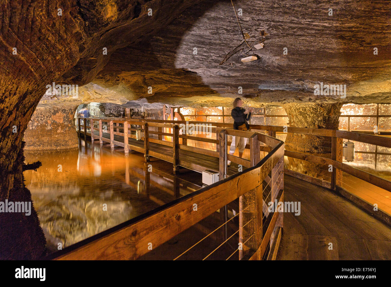 Visitors walking along a wooden walkway inside the salt mine of Bex ...