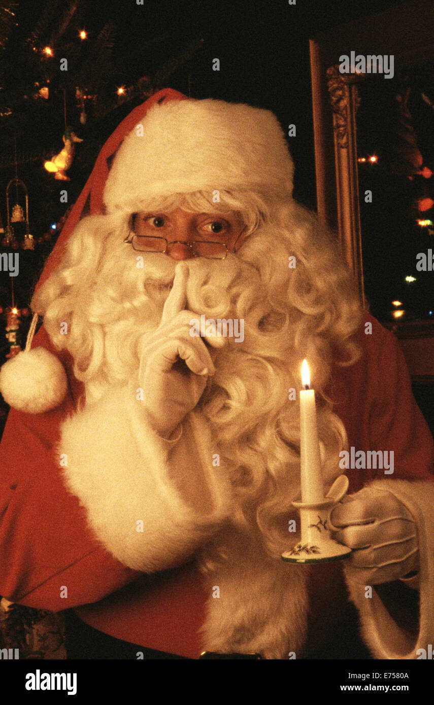 Santa Claus With Candle Gesturing Silence with Finger to Lips , Shhhhh ...