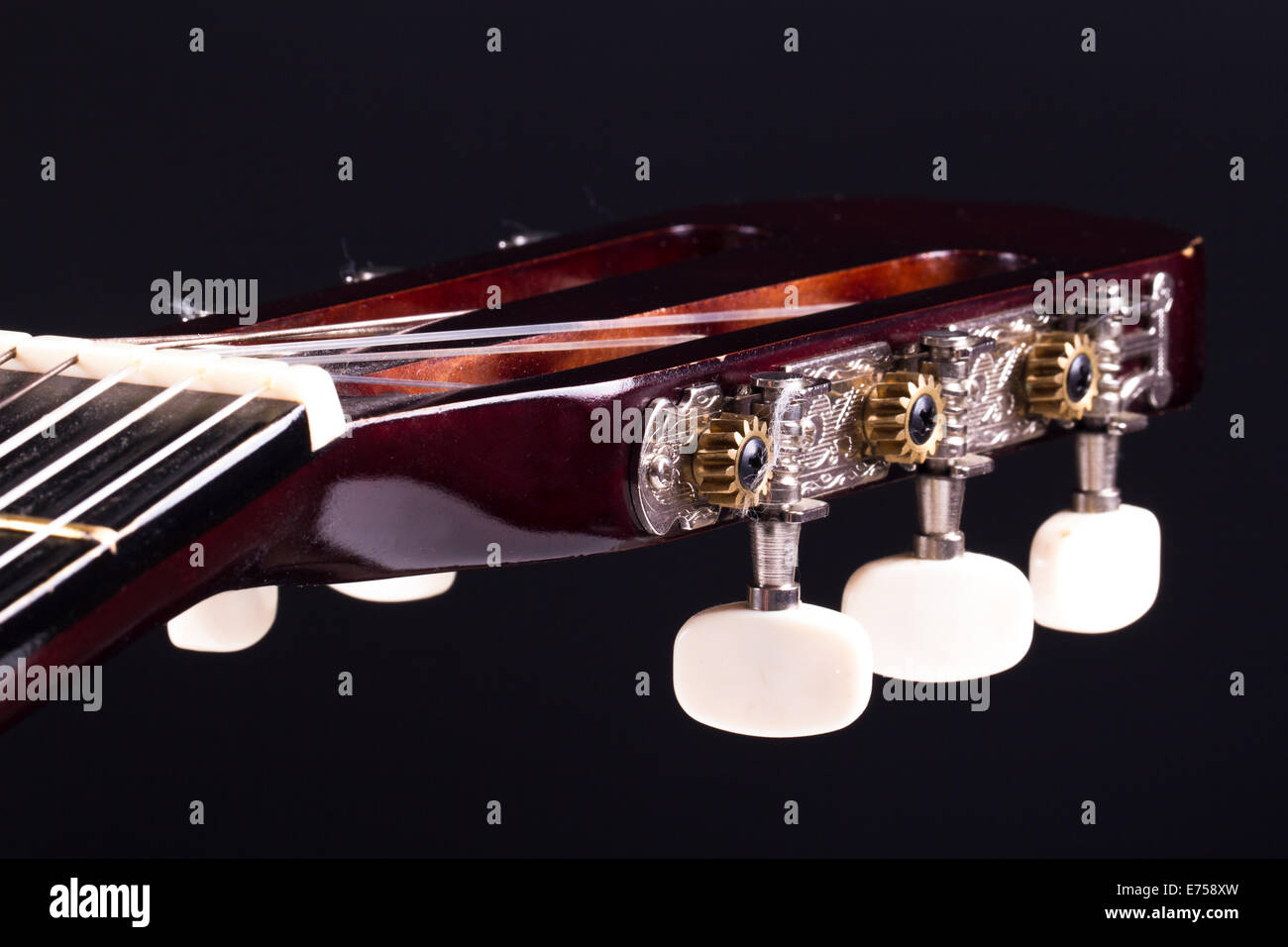 Detail view of fingerboard on classical acoustic guitar over black ...
