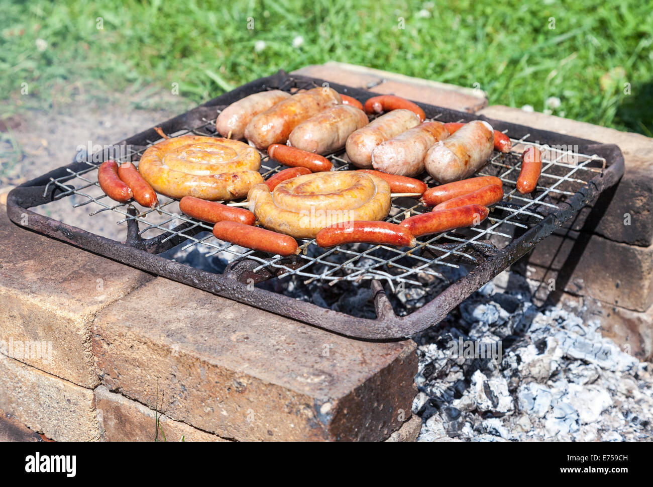 Barbecue with delicious grilled sausages on grill Stock Photo - Alamy