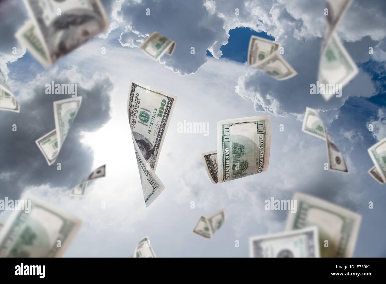 Dollar banknotes falling down with depth of field on cloudy sky ...