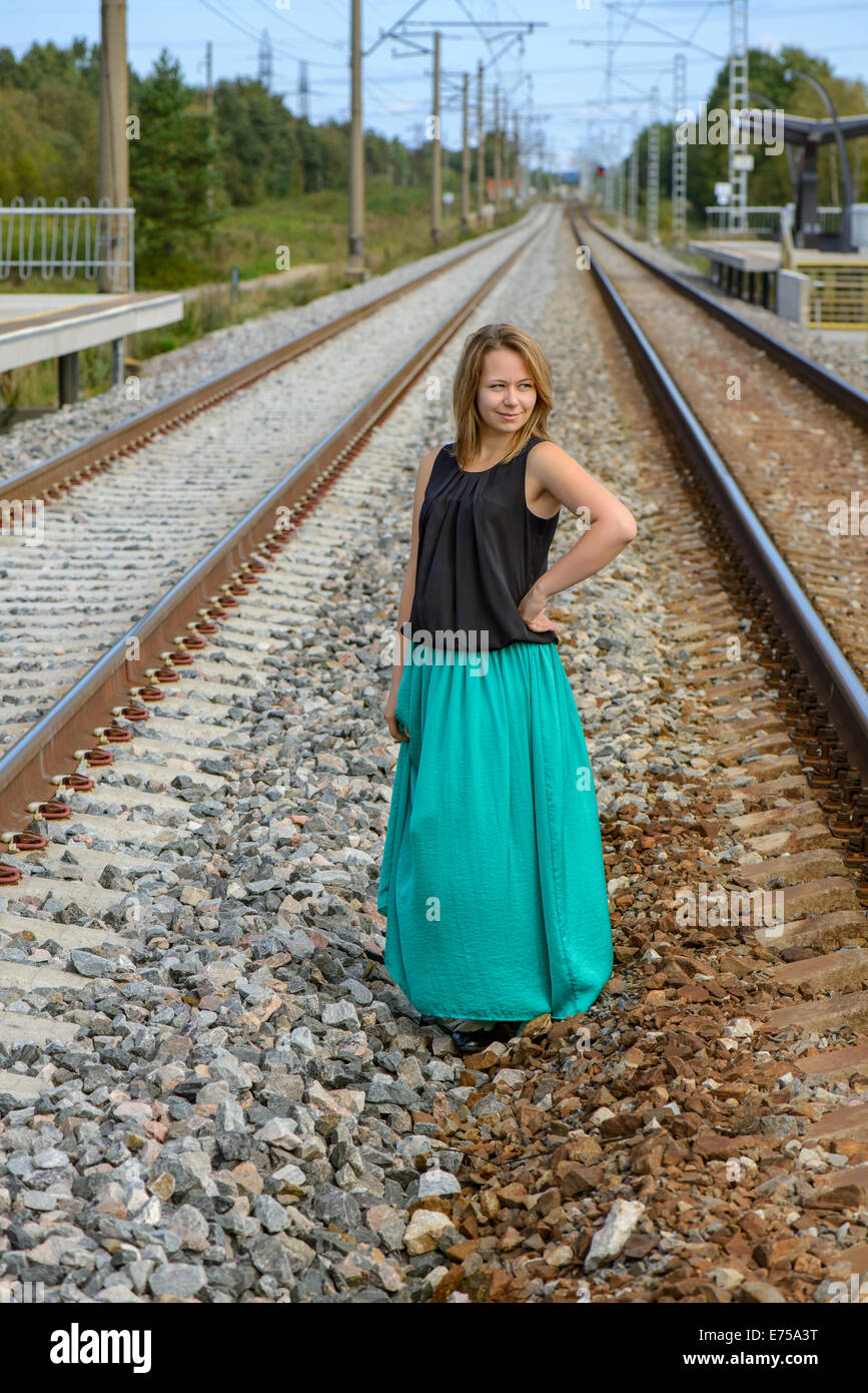 Standing girl between two railway path Stock Photo - Alamy