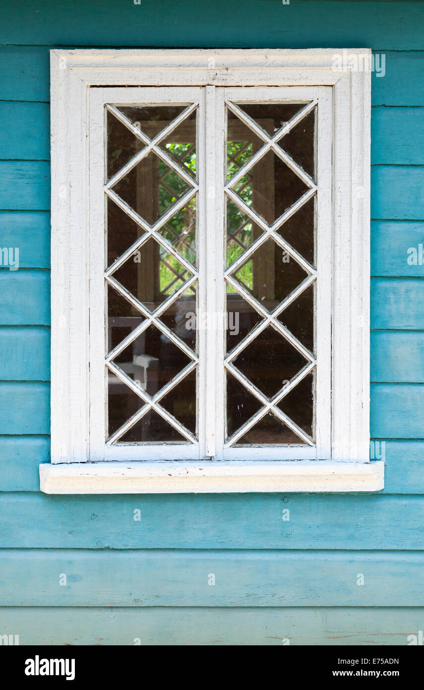 Old Russian rural house fragment, blue wall and white window Stock ...