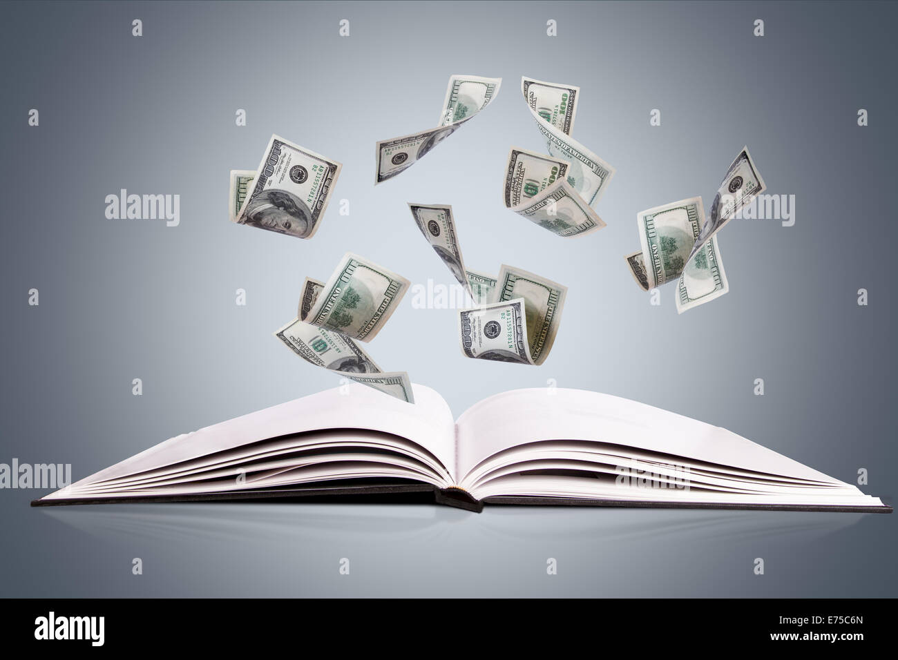 Open book or magazine with flying or falling one hundred dollar money ...