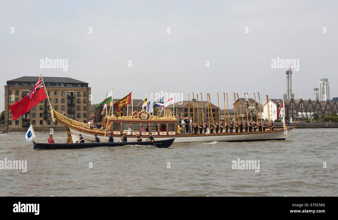 The Royal row barge Gloriana with a rowing boat on the River Thames ...