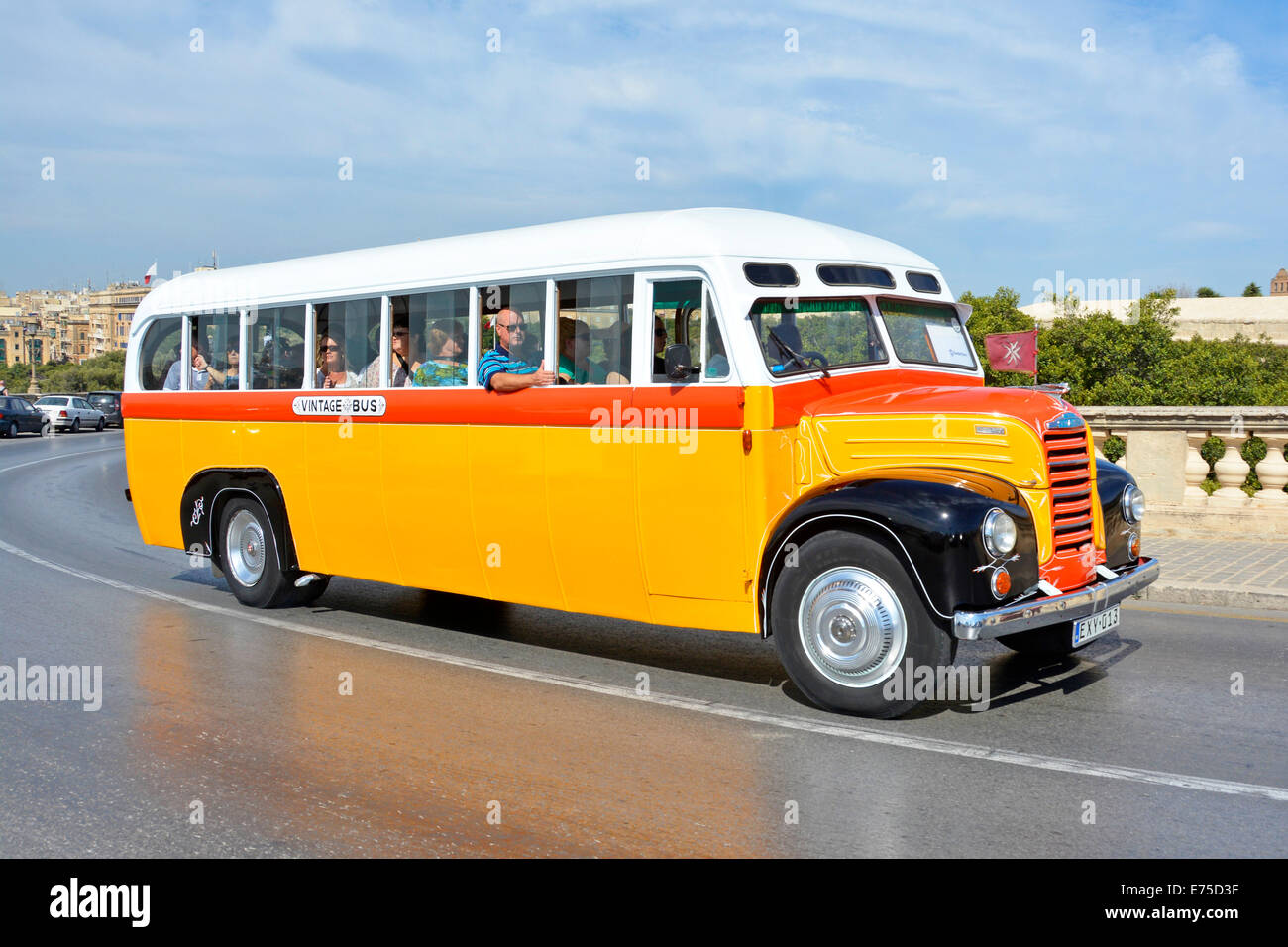 Vintage bus carrying group of people on sightseeing excursion in ...