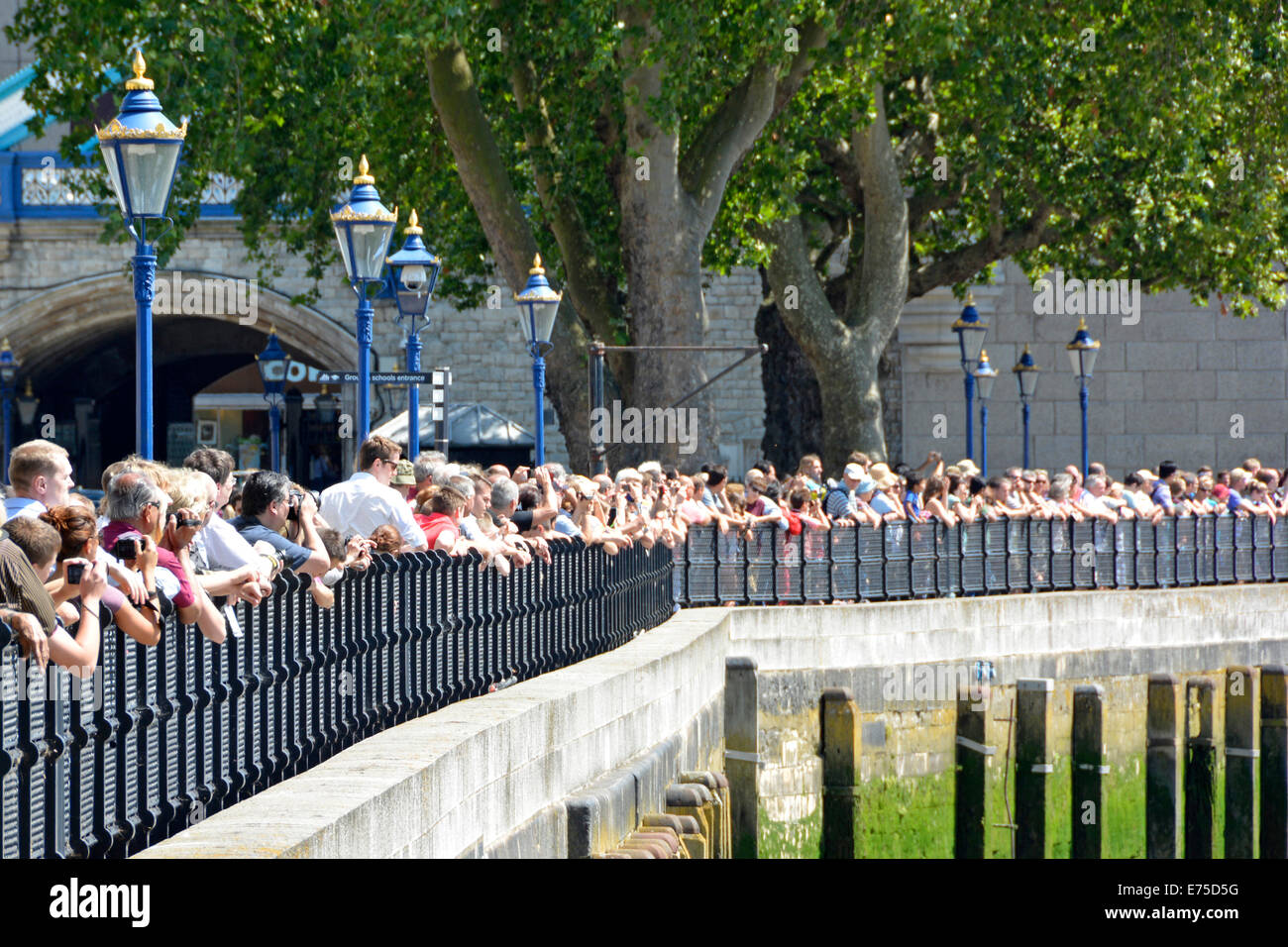 Crowd of tourists lining the riverside railings to snap the raising of ...
