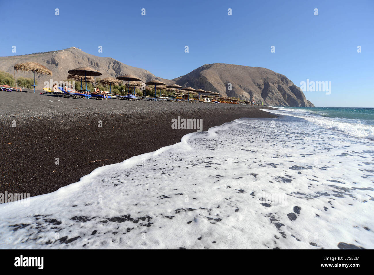 The iconic black volcanic beach at Perissa, on the world-famous ...