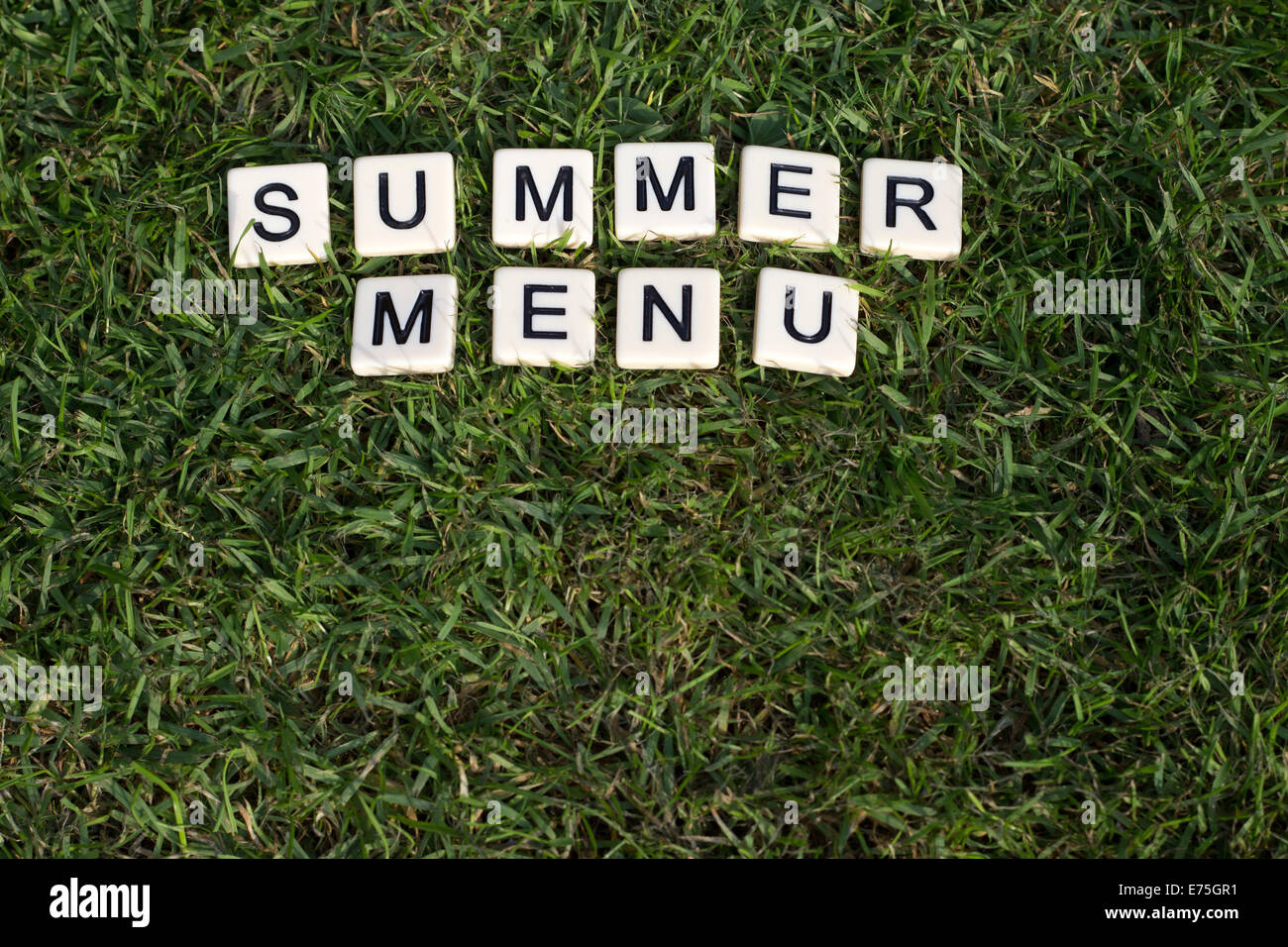 Summer Menu written in tiles on green grass Stock Photo - Alamy