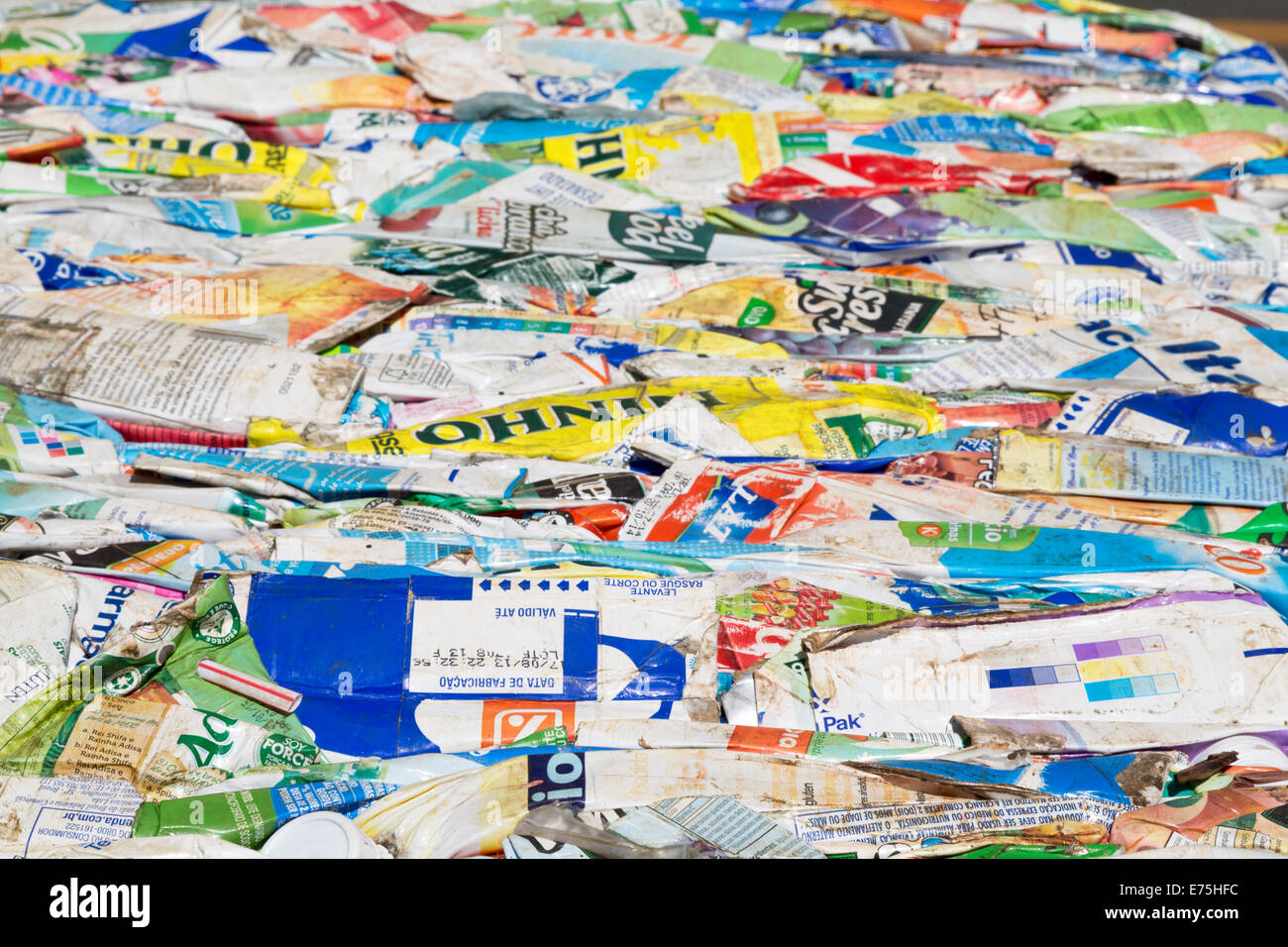Flattened and compressed cubes of milk, juice carton package. Trash ...