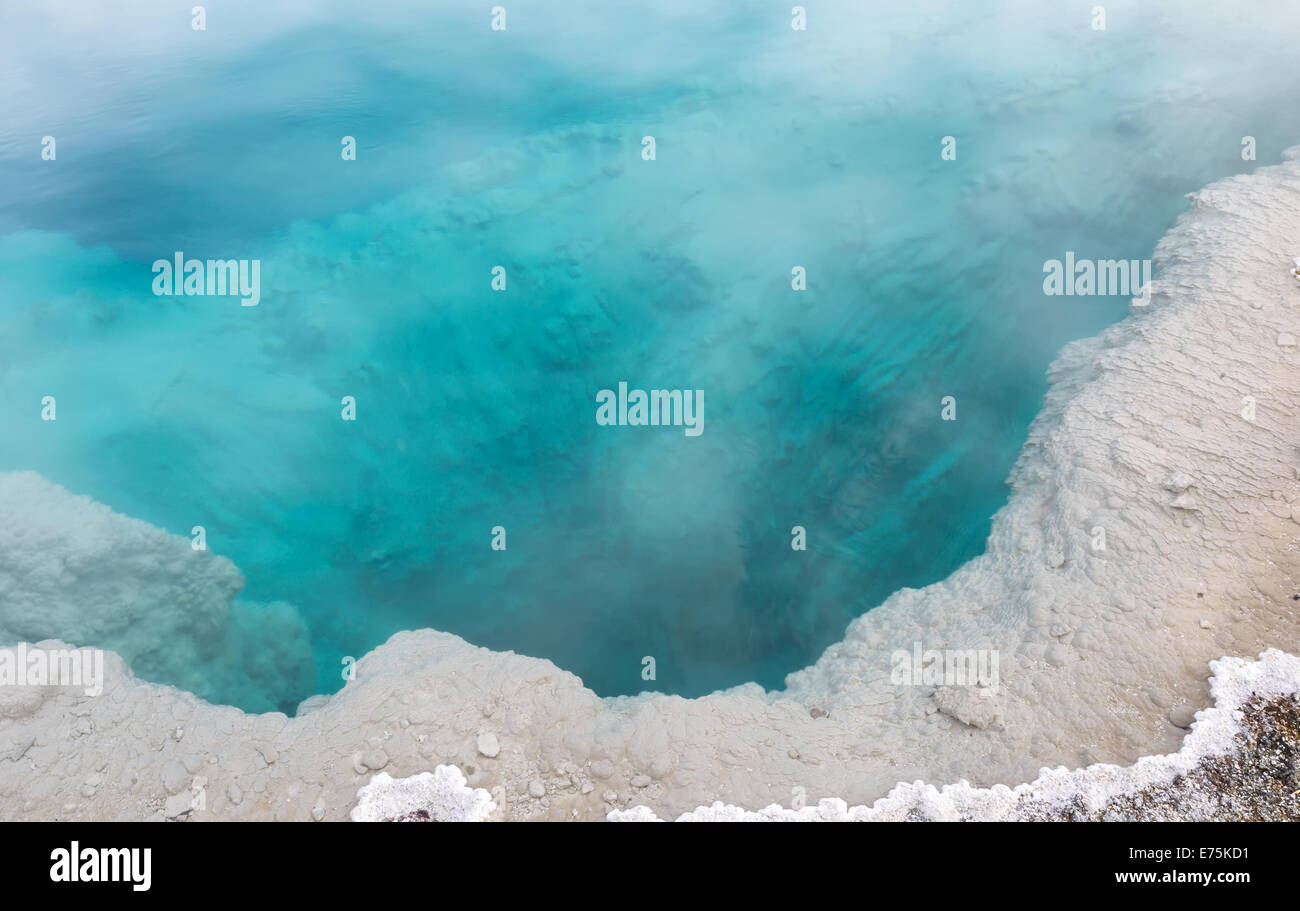 Closeup horizontal image of a deep aqua color hot spring hole in ...