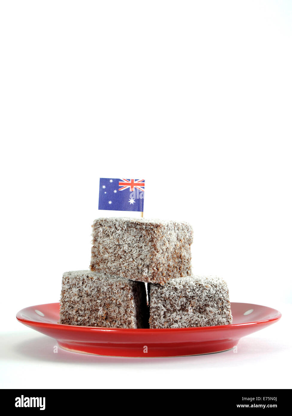 Australian traditional cake, Lamingtons, on red polka dot plate with ...