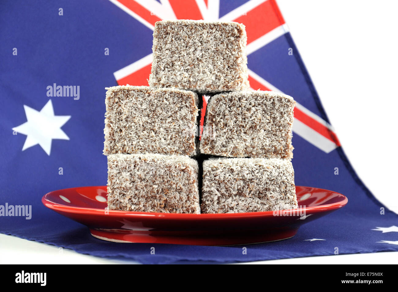 Australian traditional cake, Lamingtons, on red polka dot plate with ...