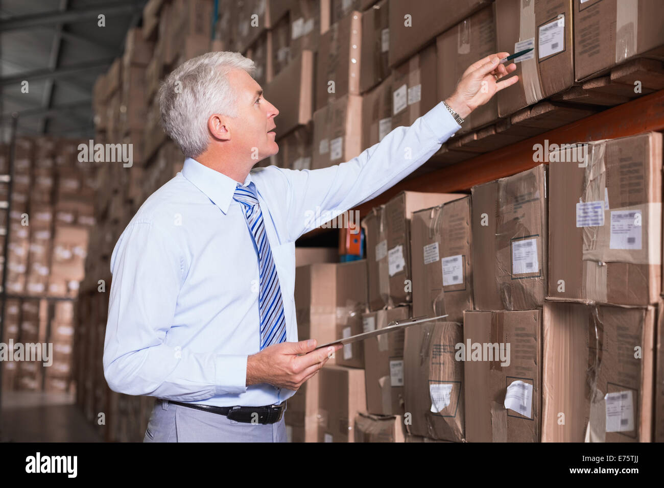 Warehouse manager checking his inventory Stock Photo - Alamy