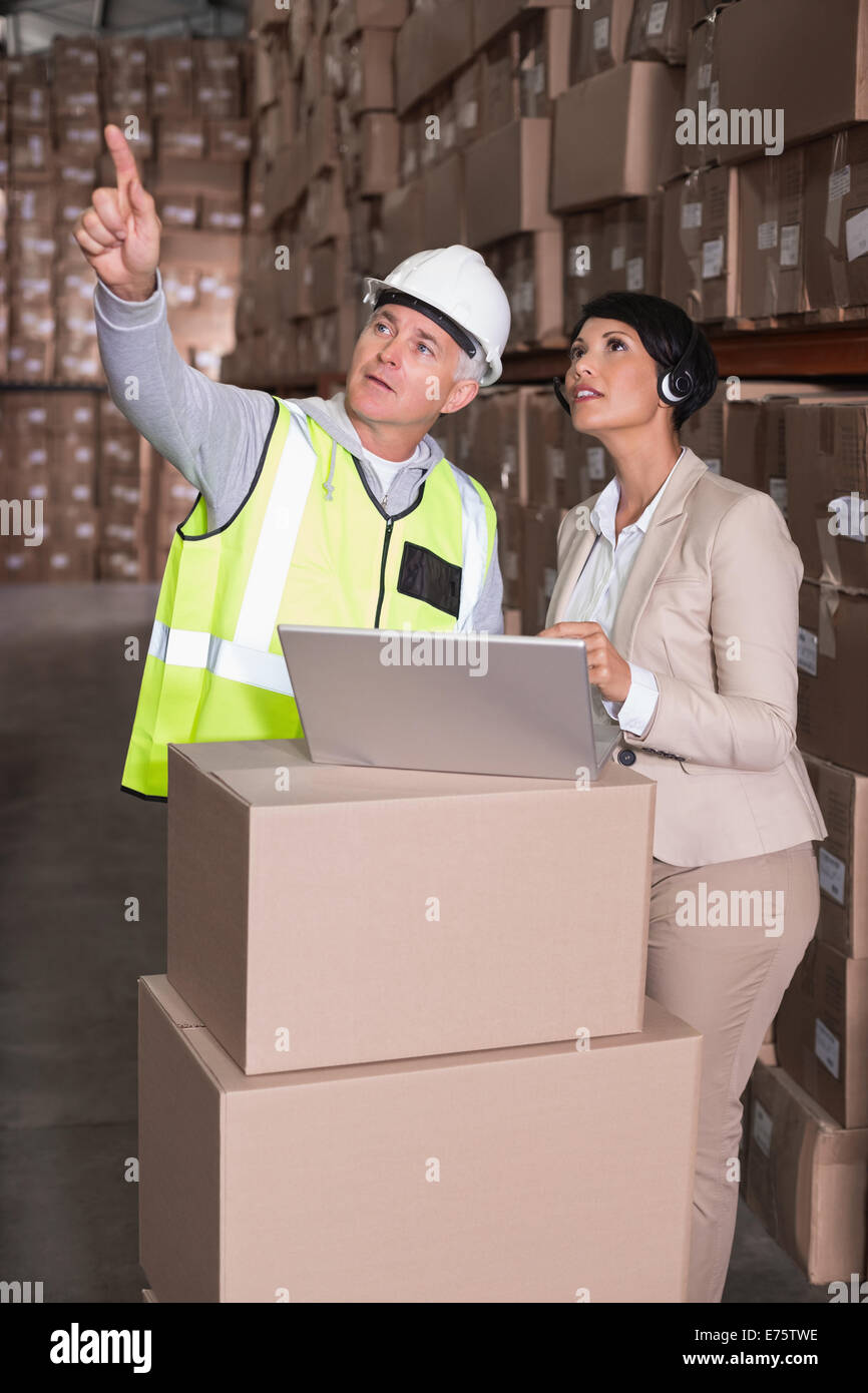 Warehouse worker and manager using laptop Stock Photo - Alamy