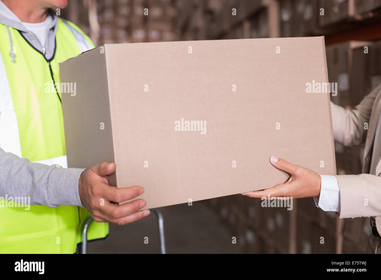 Man passing woman a box hi-res stock photography and images - Alamy