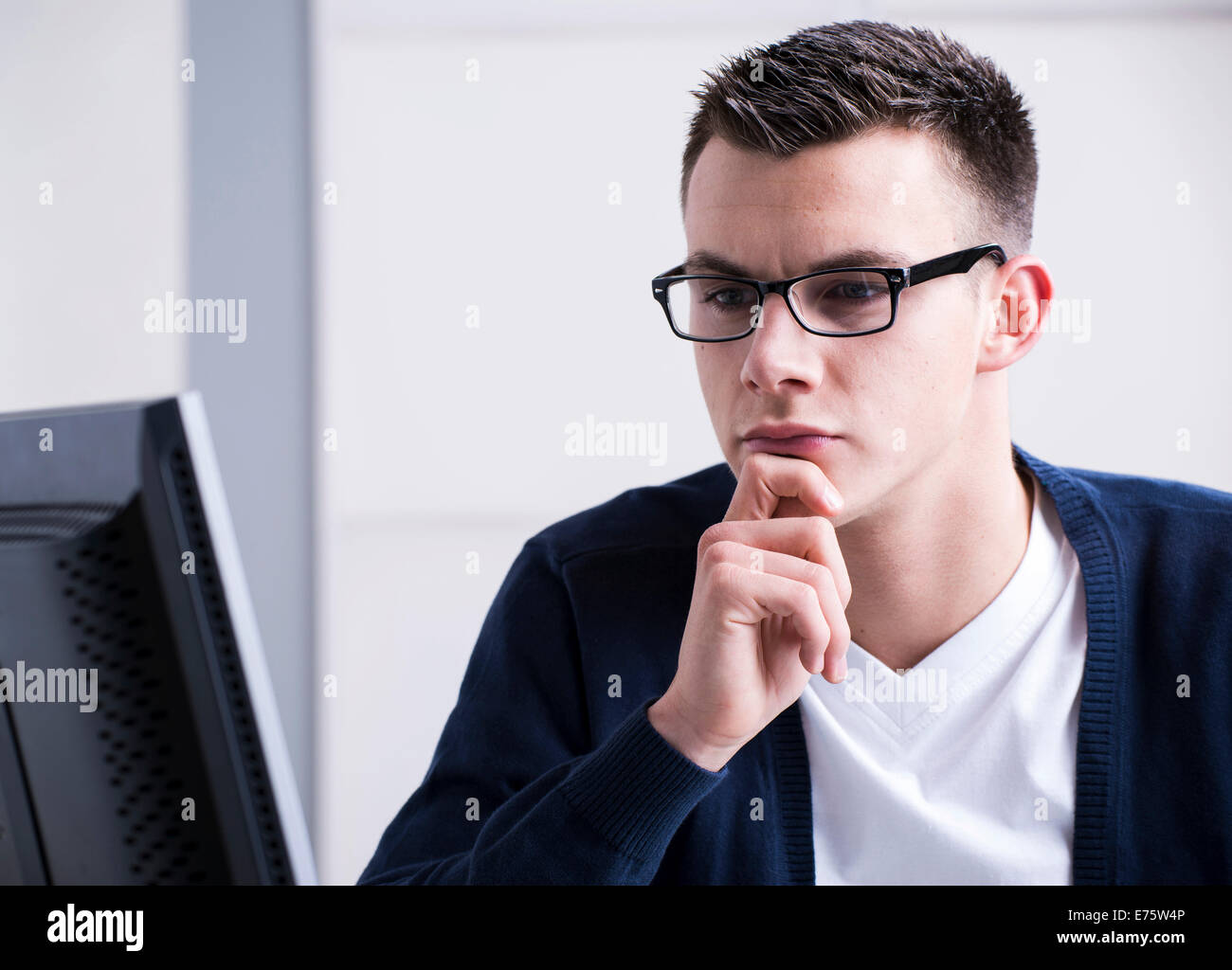 Young man working on a computer Stock Photo - Alamy