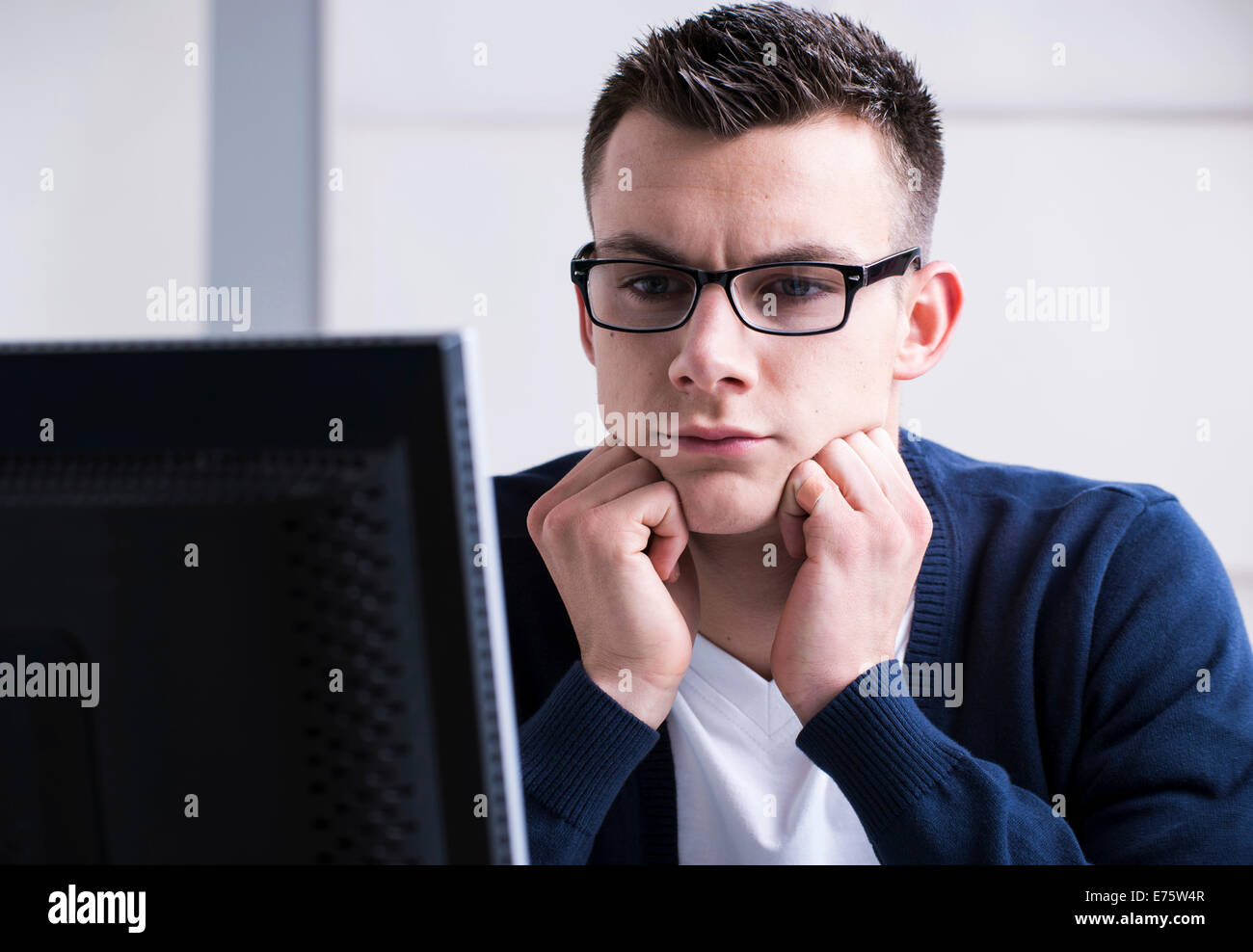 Young man working on a computer Stock Photo - Alamy