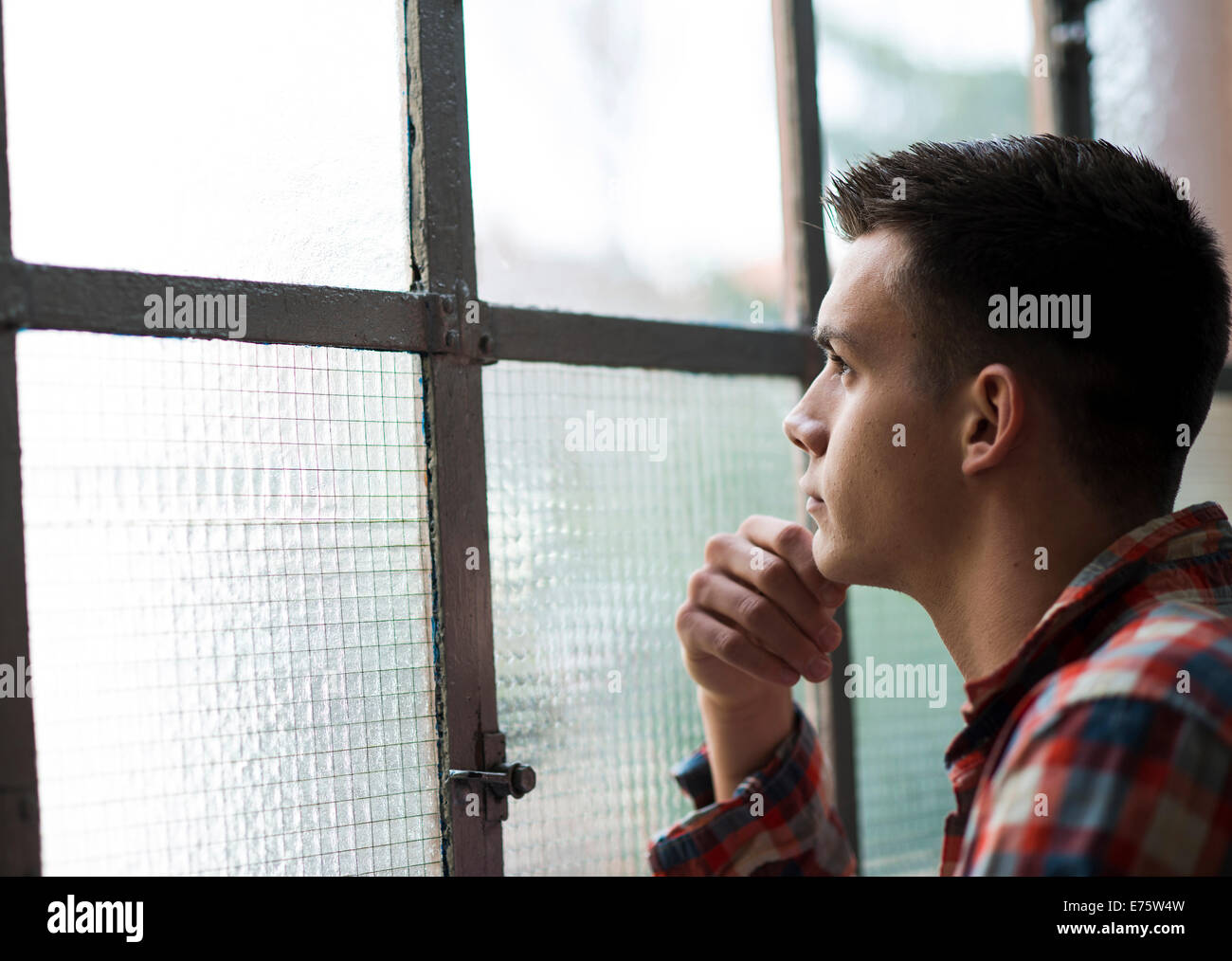 A young man at his window hi-res stock photography and images - Alamy