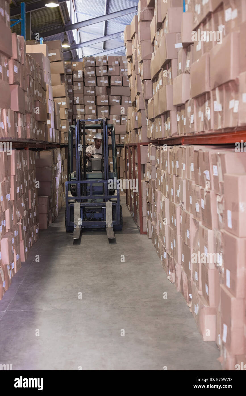 Forklift driver operating the machine Stock Photo - Alamy