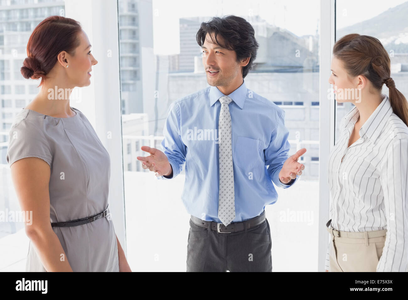 Businessman discussing work with co-workers Stock Photo - Alamy